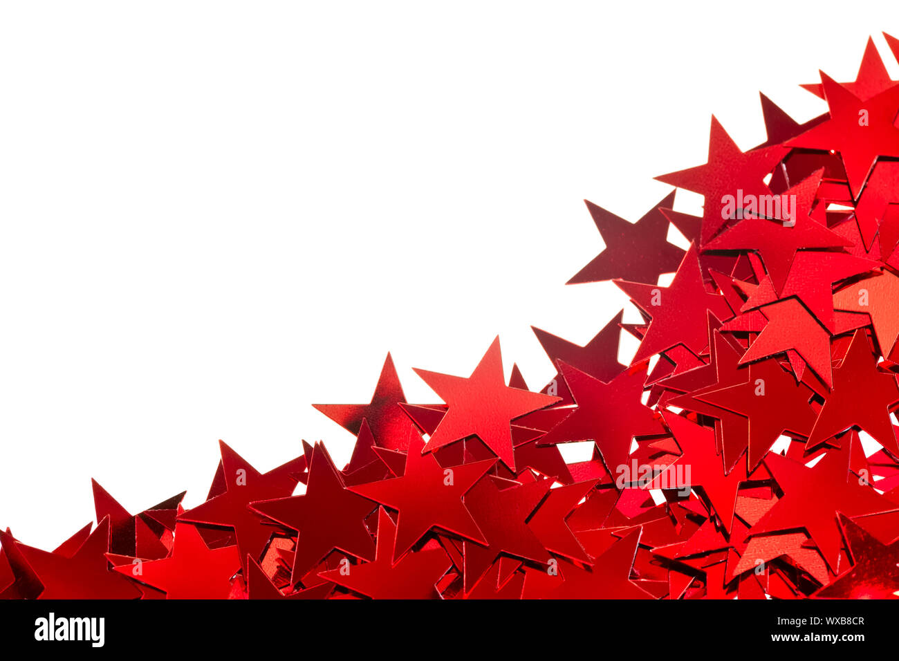 Red star shaped confetti on white background Stock Photo - Alamy