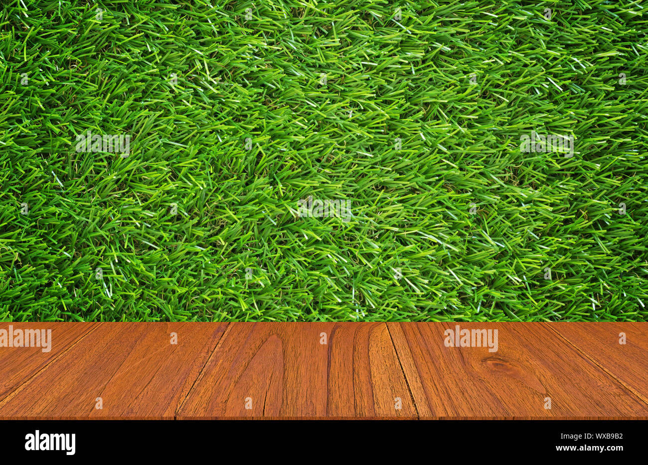 Wood table on green grass background, montage or display product ...