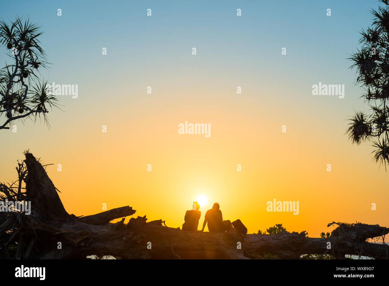 Romantic couple at beach at sunset Stock Photo - Alamy