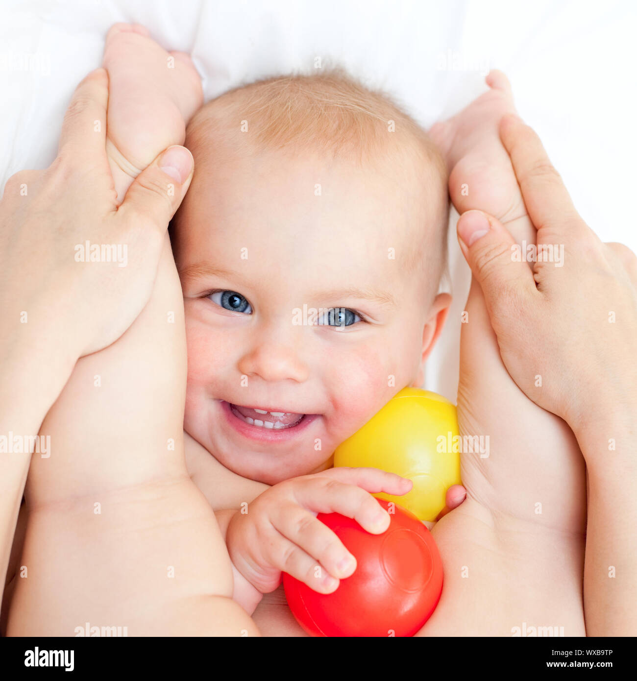 Cute little baby girl taking exercise Stock Photo - Alamy