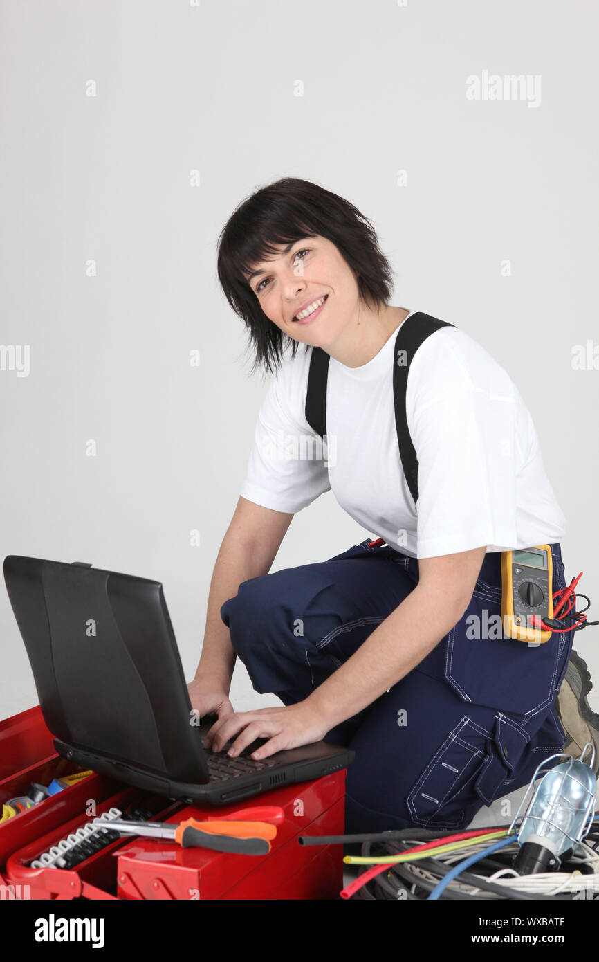 Female electrician surrounded by equipment Stock Photo - Alamy