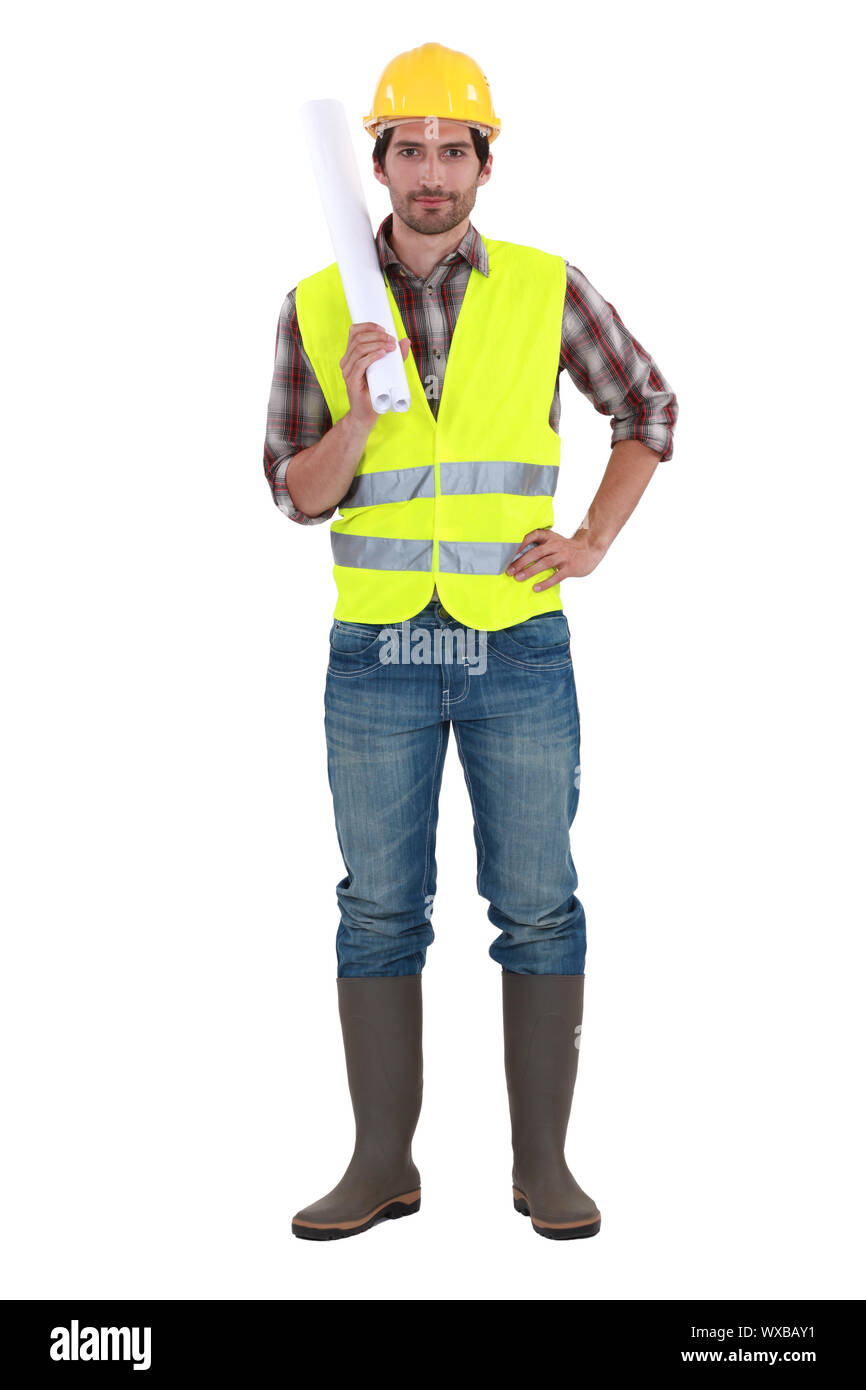 Engineer in a reflective vest with plans Stock Photo - Alamy