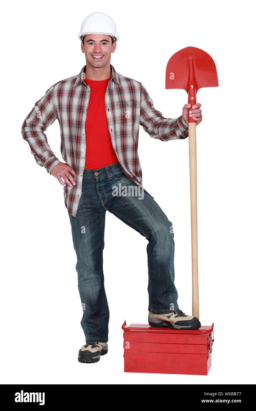 Builder with a shovel Stock Photo - Alamy