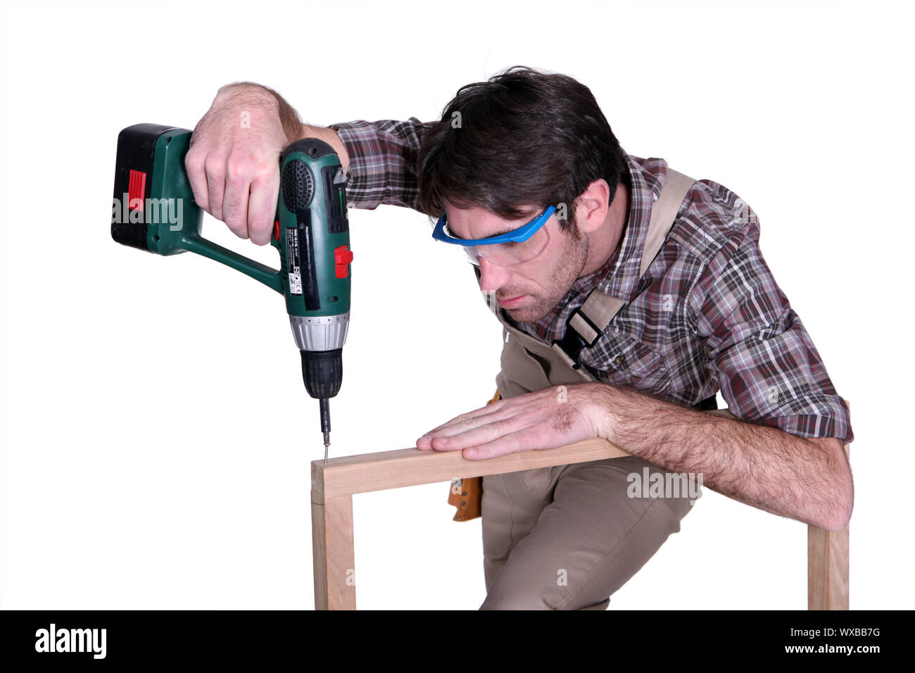 Worker using an electric screwdriver Stock Photo - Alamy