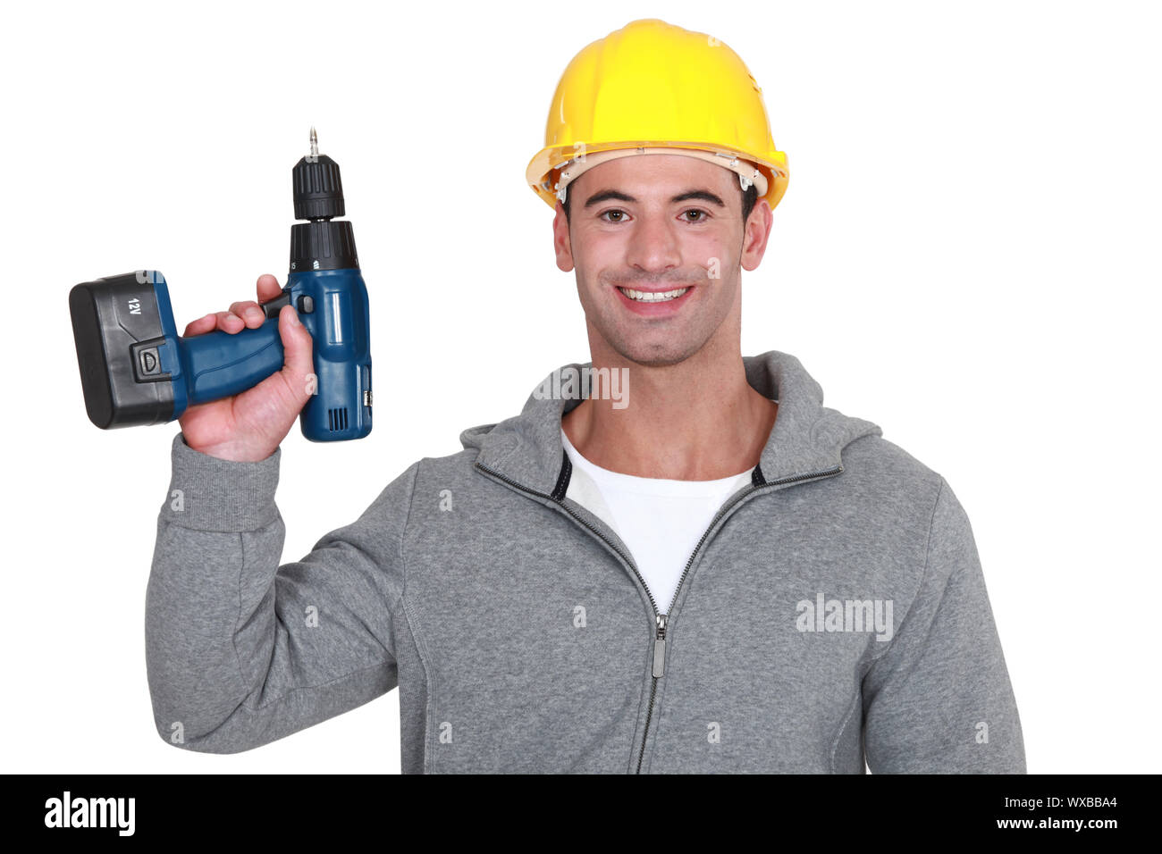 Tradesman holding up a screw gun Stock Photo - Alamy