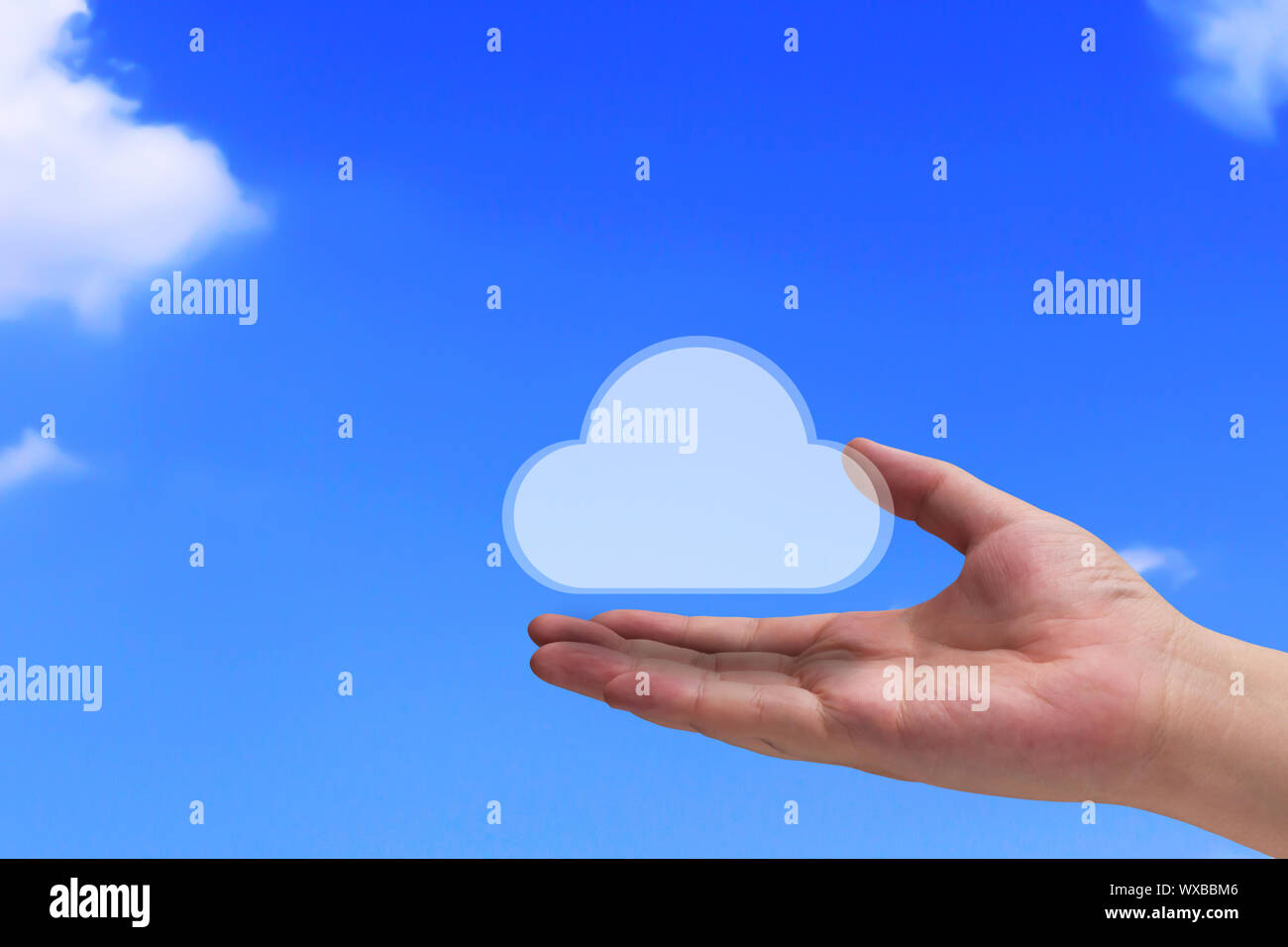 Cloud computing technology concept, hand on blue sky background ...