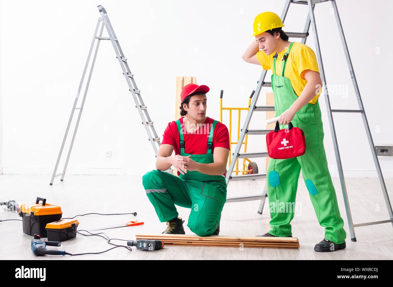 Injured worker and his workmate Stock Photo - Alamy