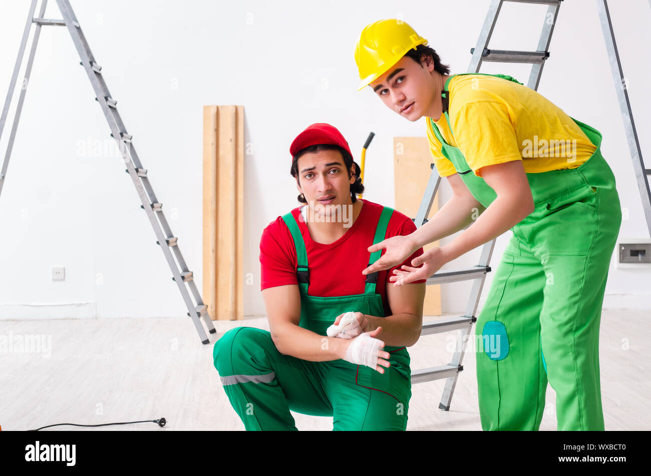 Injured worker and his workmate Stock Photo - Alamy