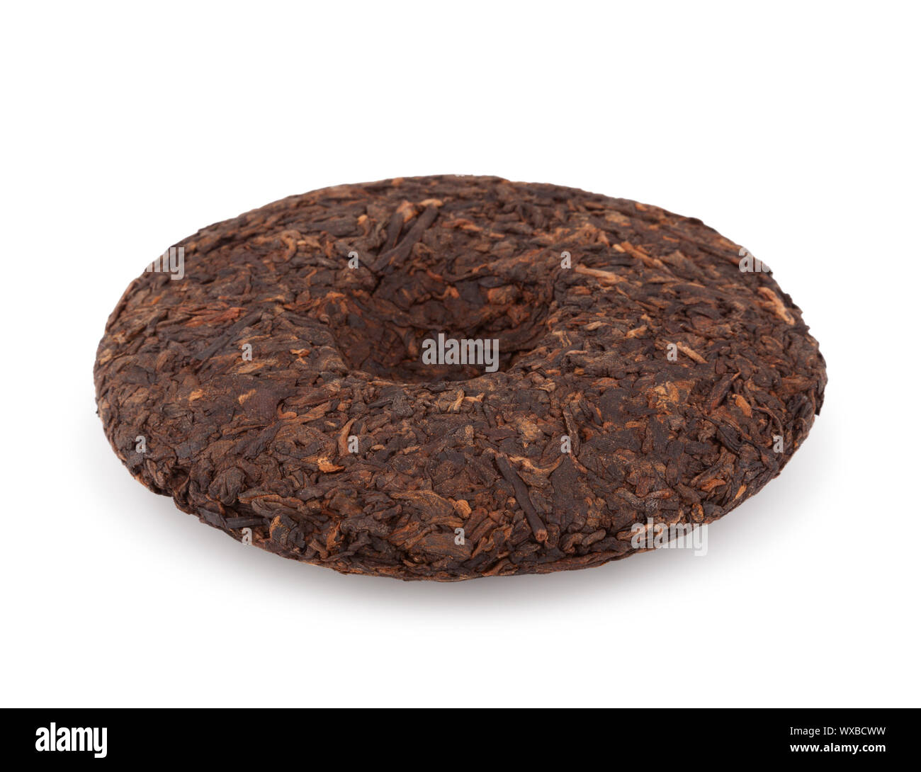 Disc of exotic puer tea isolated on a white background Stock Photo - Alamy