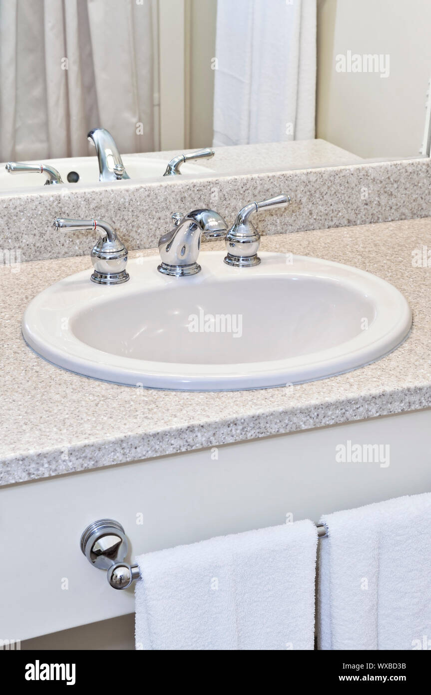 Bathroom interior with white sink, faucet and mirror Stock Photo - Alamy