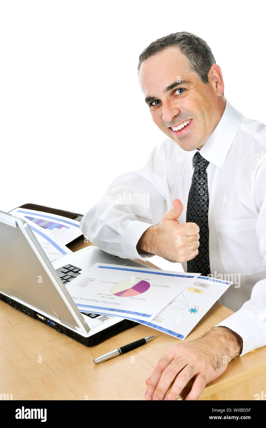 Happy smiling businessman sitting at his desk isolated on white ...