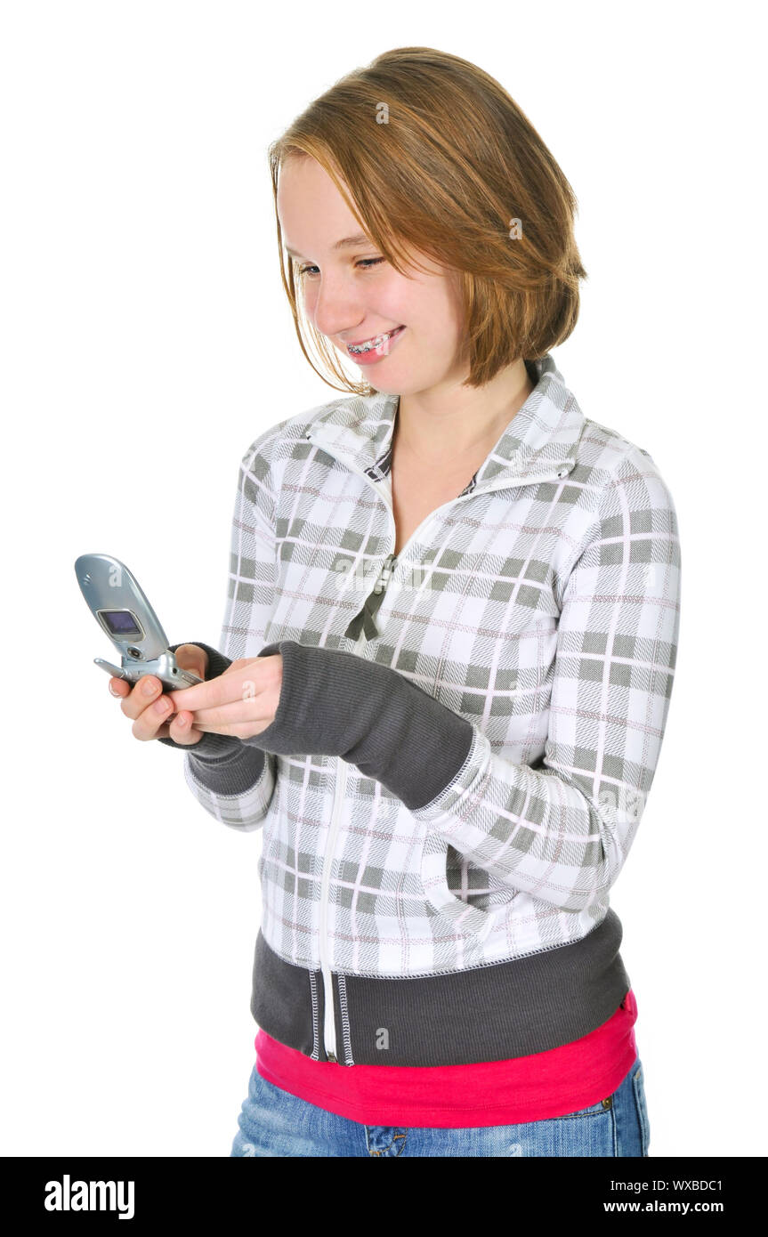 Teenage girl text messaging on a cell phone isolated on white ...