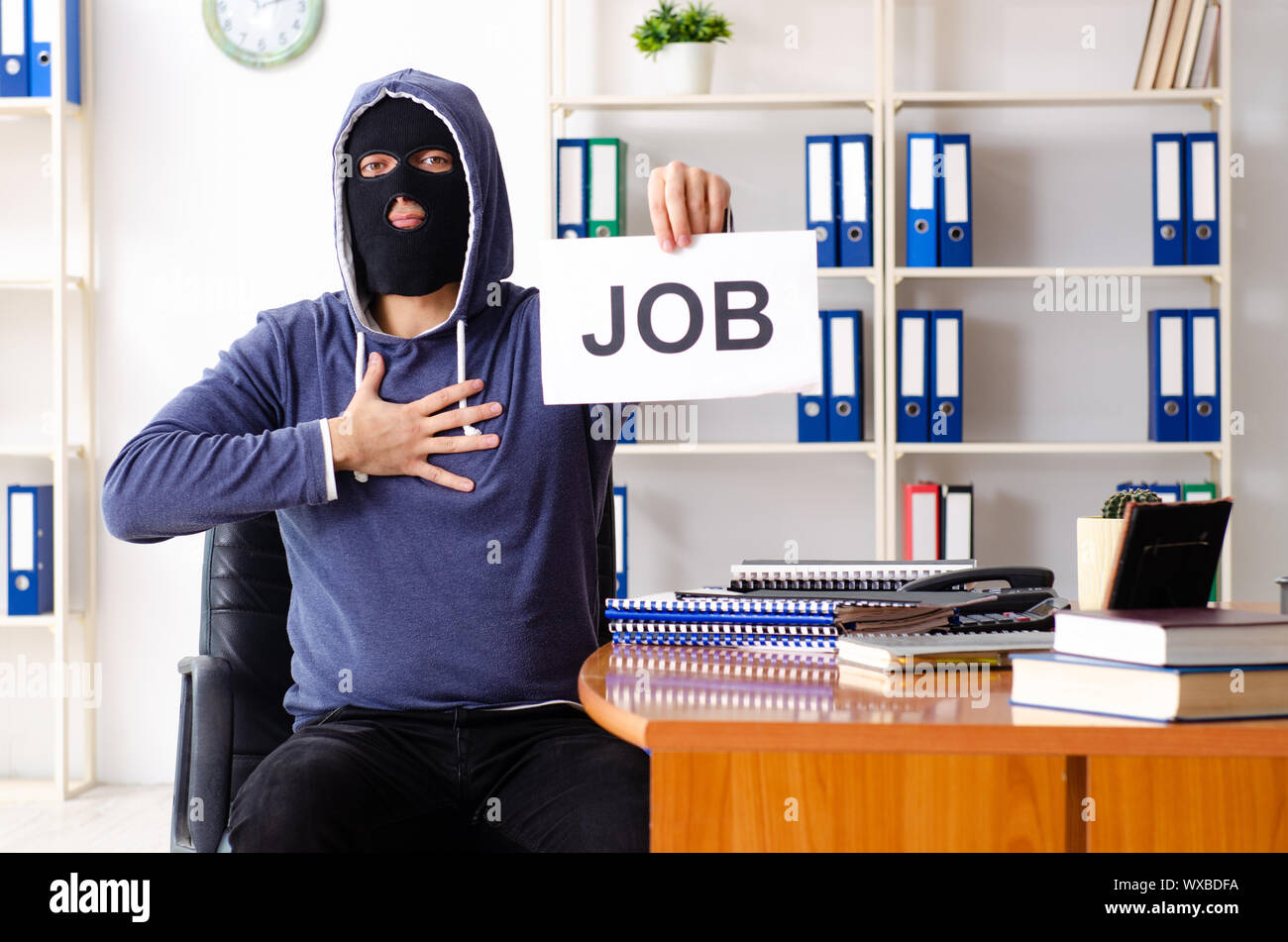 Male thief in balaclava in the office Stock Photo - Alamy