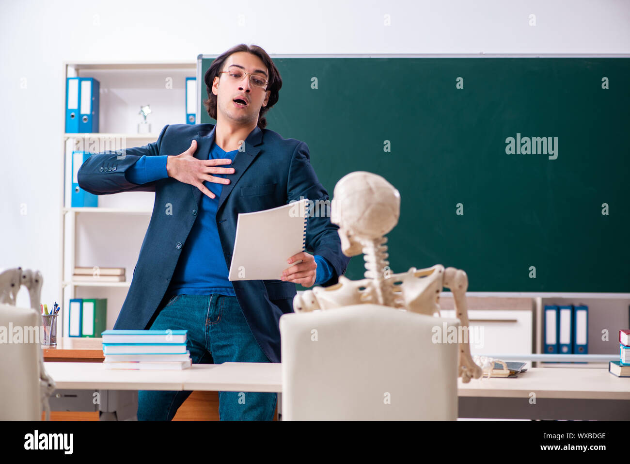 Male teacher and skeleton student in the classroom Stock Photo - Alamy