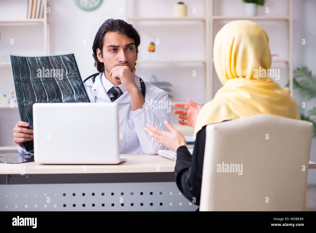 Female arab patient visiting male doctor Stock Photo - Alamy
