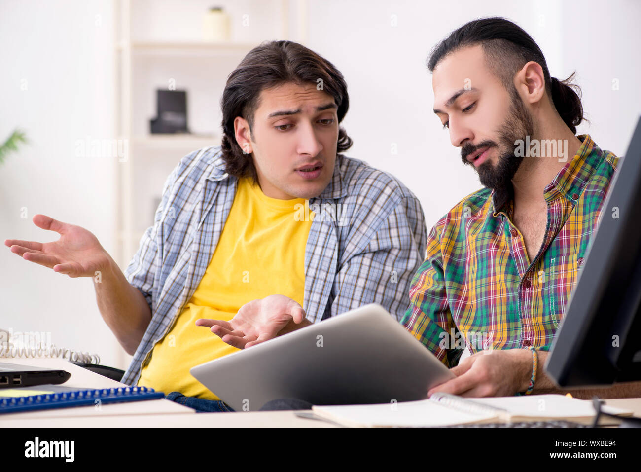 Two it specialists working in the office Stock Photo - Alamy