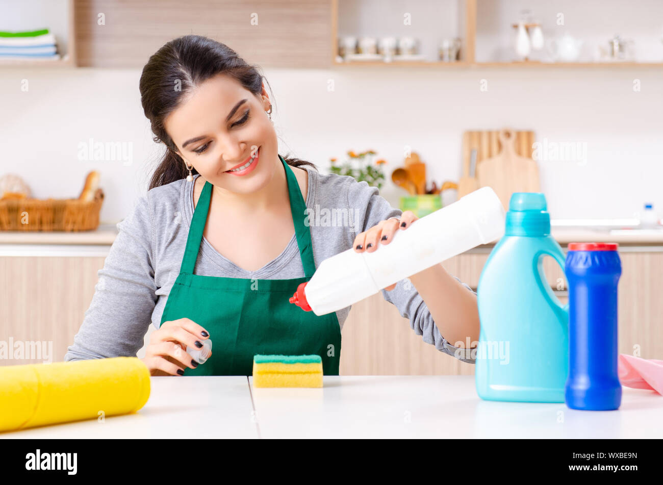 Young female contractor doing housework Stock Photo - Alamy