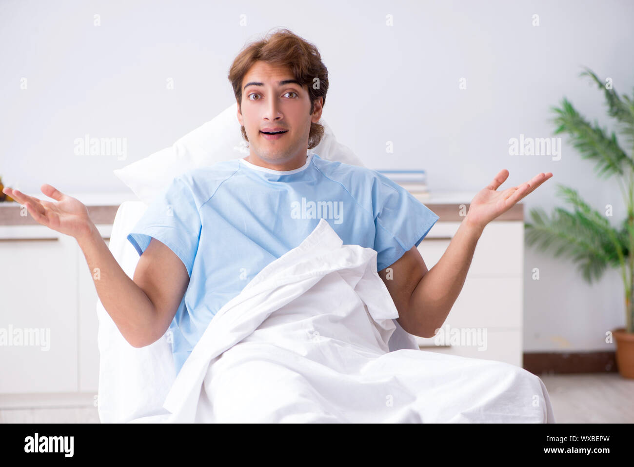 Young male patient lying on couch in hospital Stock Photo - Alamy