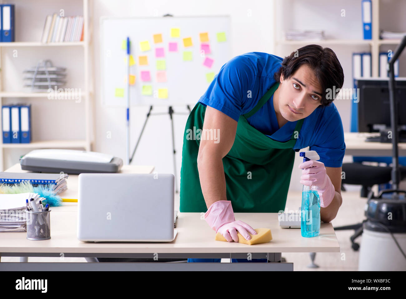 Male handsome professional cleaner working in the office Stock Photo ...
