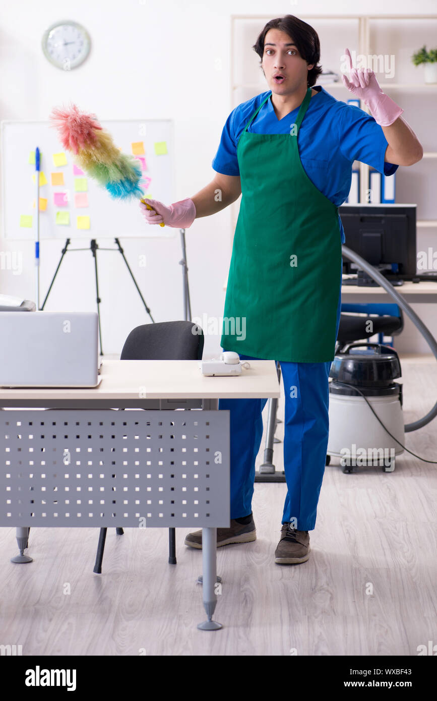 Male handsome professional cleaner working in the office Stock Photo ...