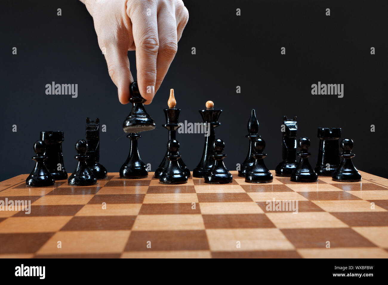 hand moves chess pawn on a dark background Stock Photo - Alamy