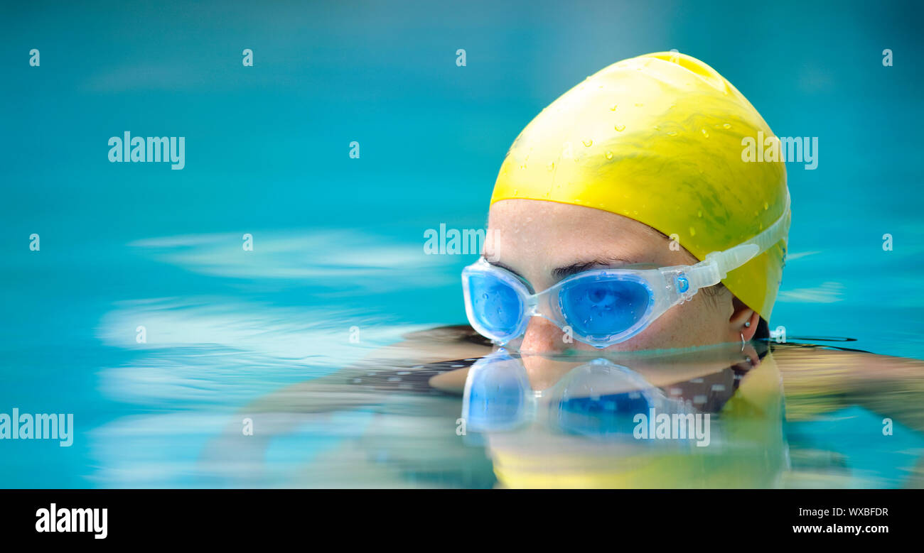 Submerged swimmer looks over the water surface Stock Photo - Alamy