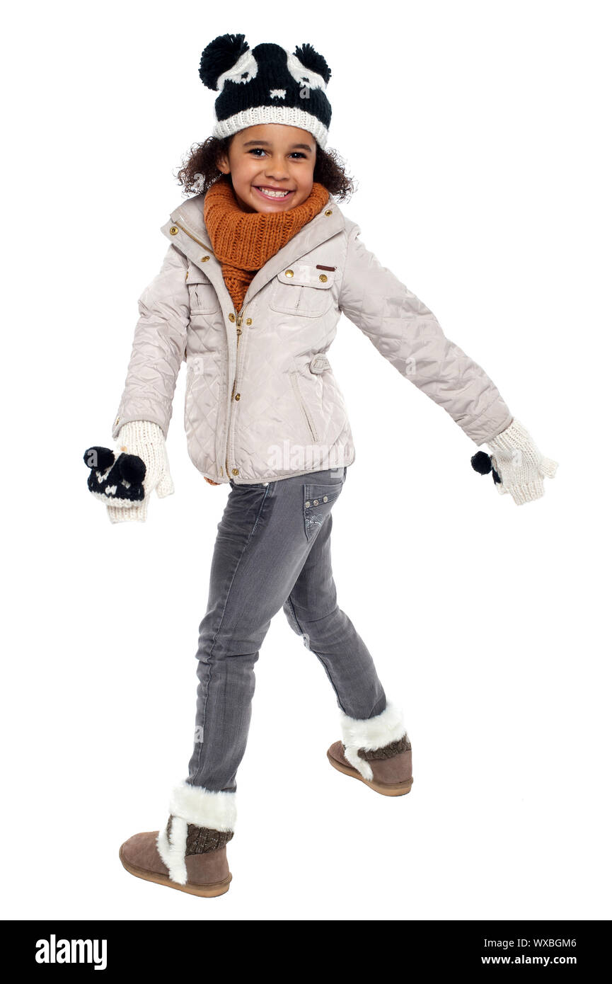 Fun loving girl in playful mood turning back and smiling at the camera ...