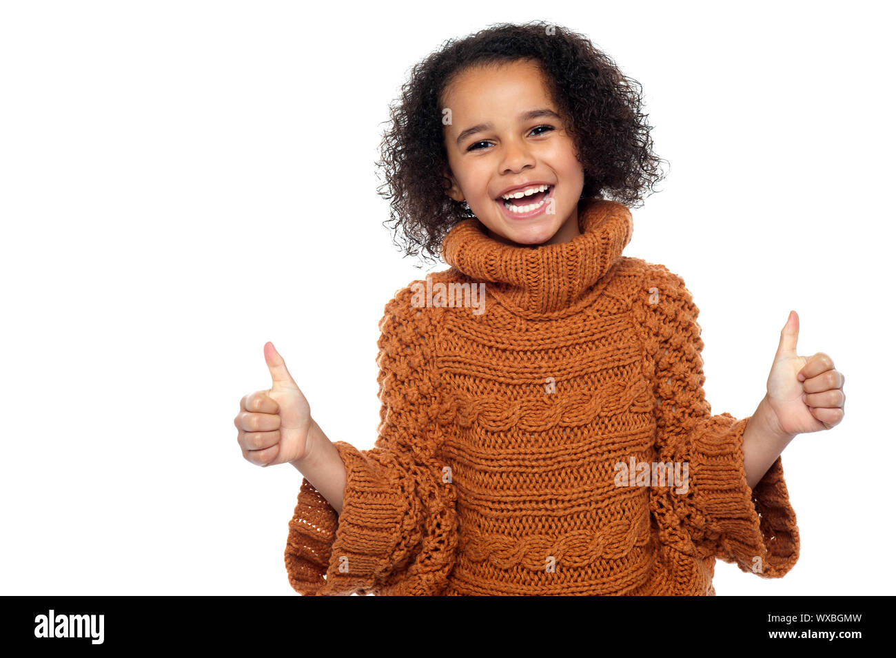 Pretty kid laughing and showing double thumbs up gesture to camera ...