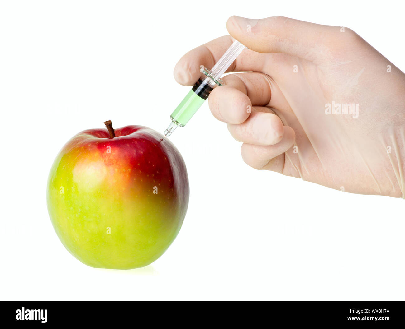 Green apple receiving an injection for rapid ripening Stock Photo - Alamy