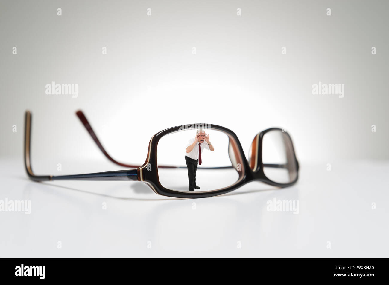Conceptual photograph of life size glasses and a male model looking ...
