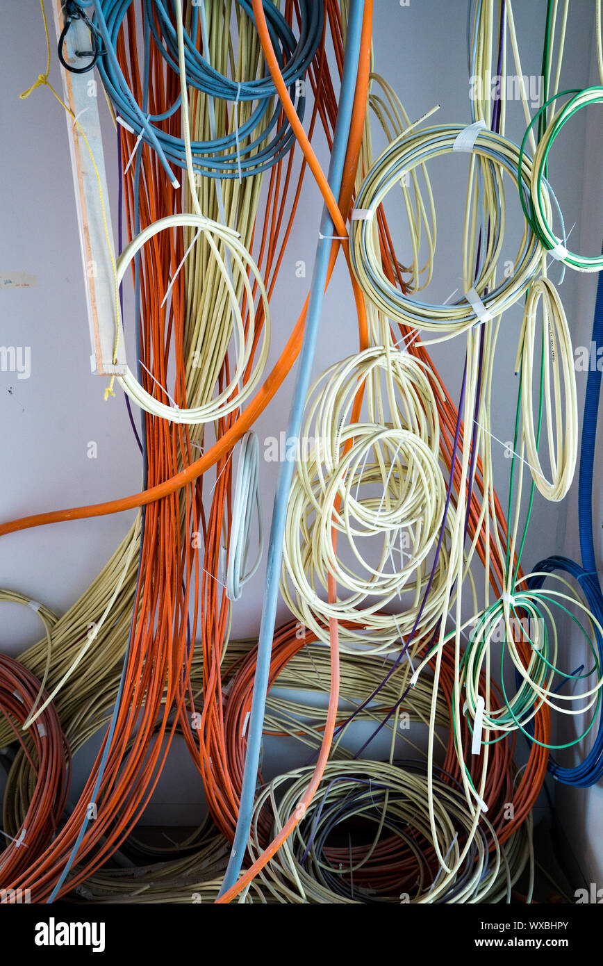 colorful electrical cables hanging from the ceiling in spirals and ...
