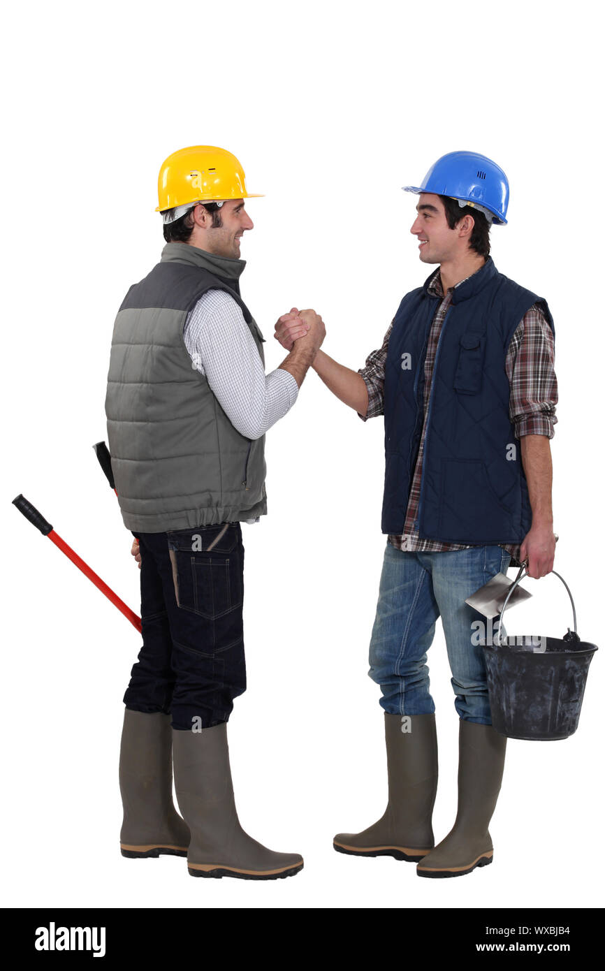 Two construction workers greeting each other Stock Photo - Alamy
