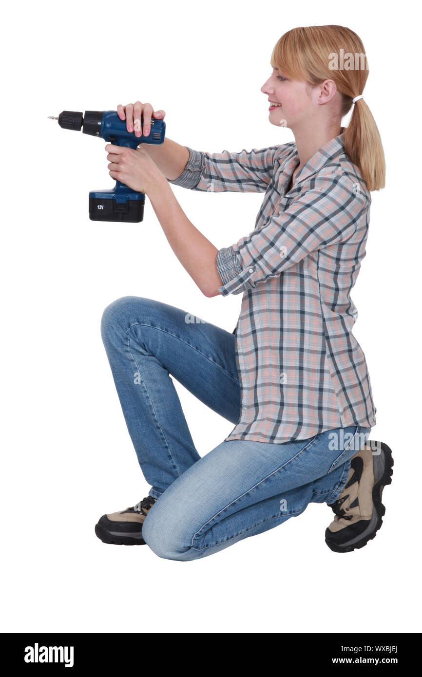 A woman making a hole in the wall Stock Photo - Alamy