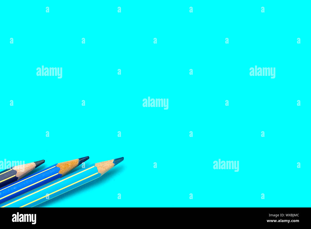 colored blue pencils on a bright blue background Stock Photo - Alamy