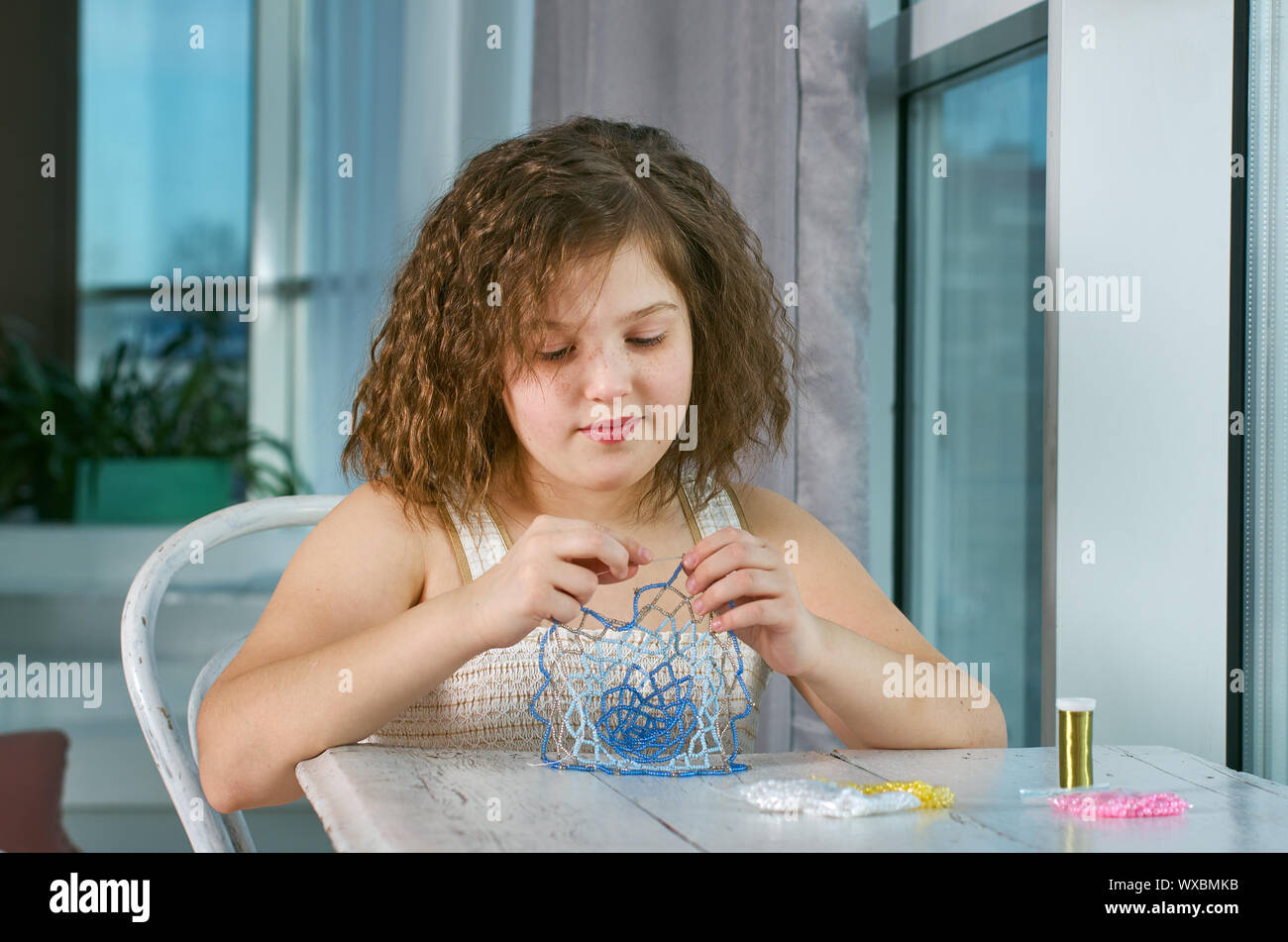Little girl making jewelry Stock Photo - Alamy