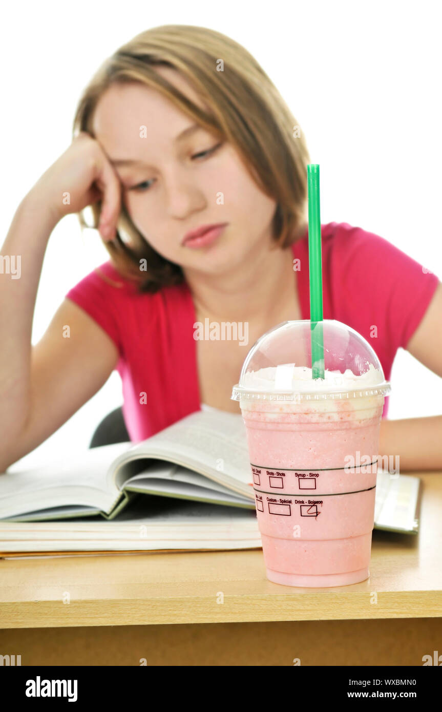 Teenage school girl studying with a milkshake Stock Photo - Alamy