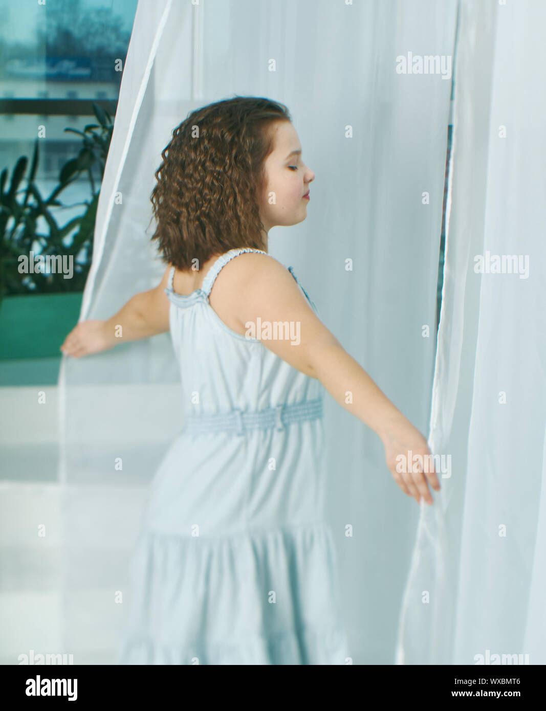 girl standing near big window Stock Photo - Alamy