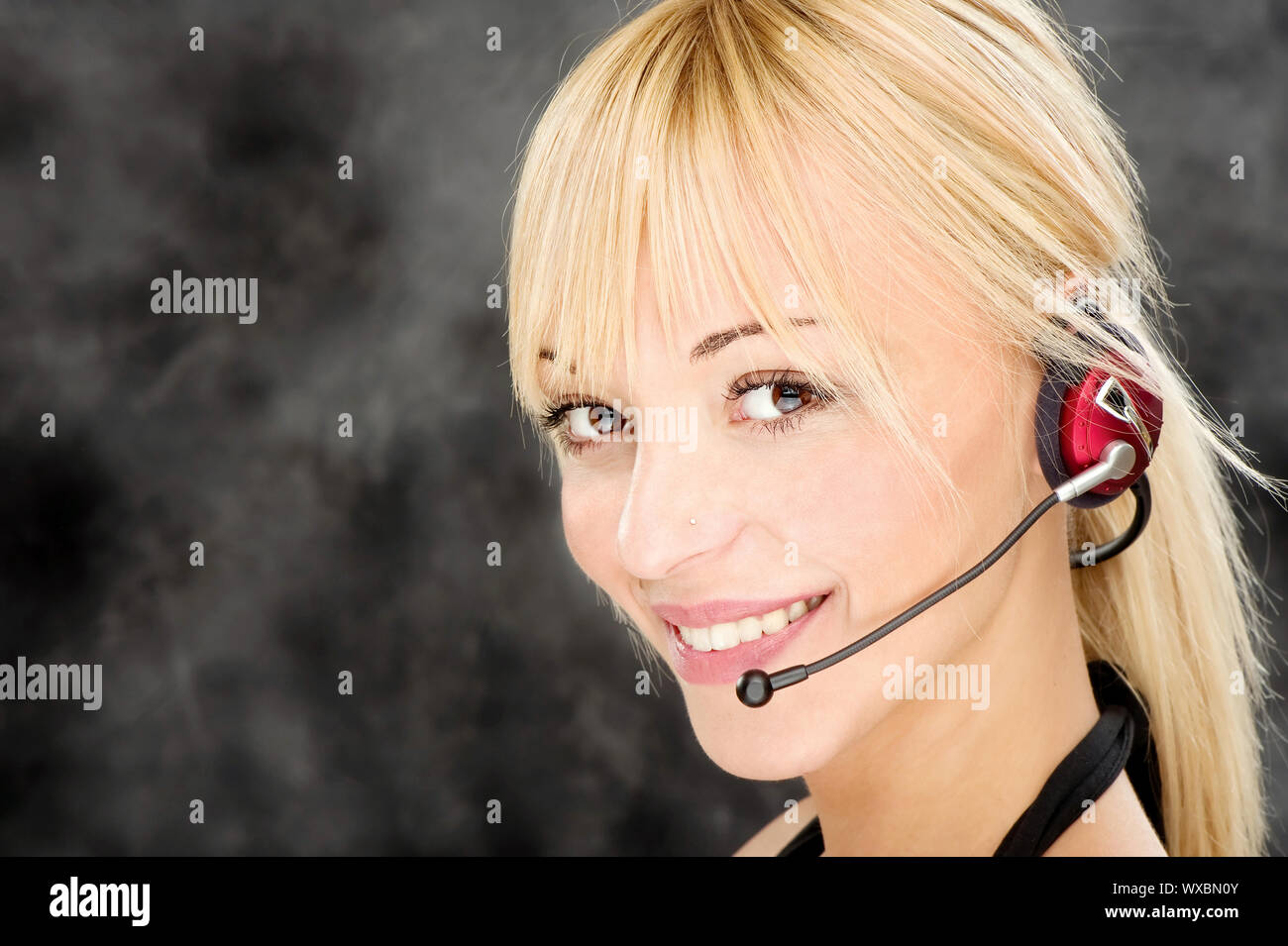 Blond woman as a telephone operator Stock Photo - Alamy
