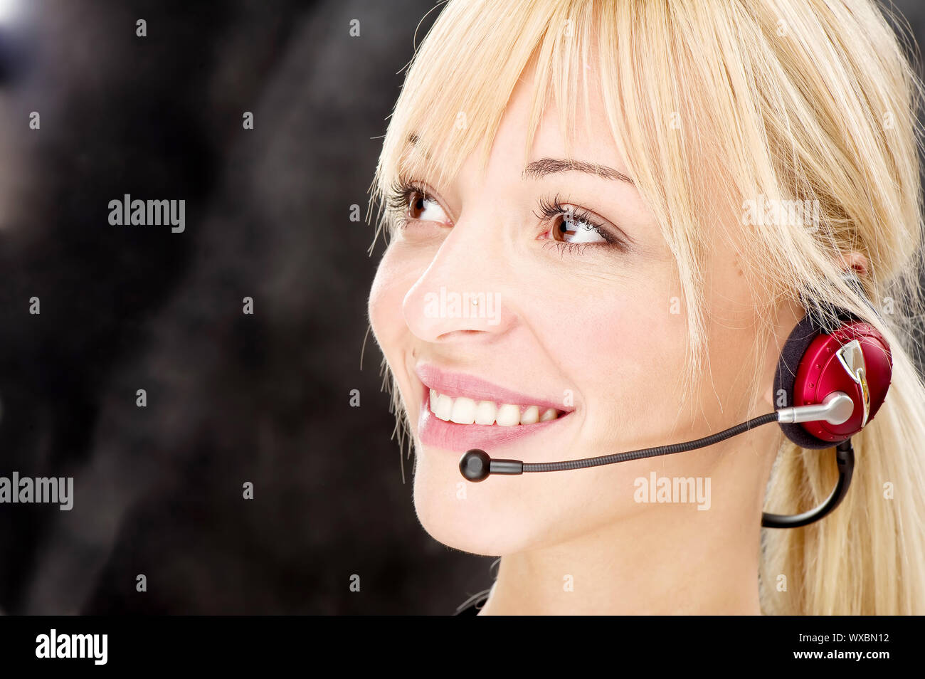 Blond woman as a telephone operator Stock Photo - Alamy