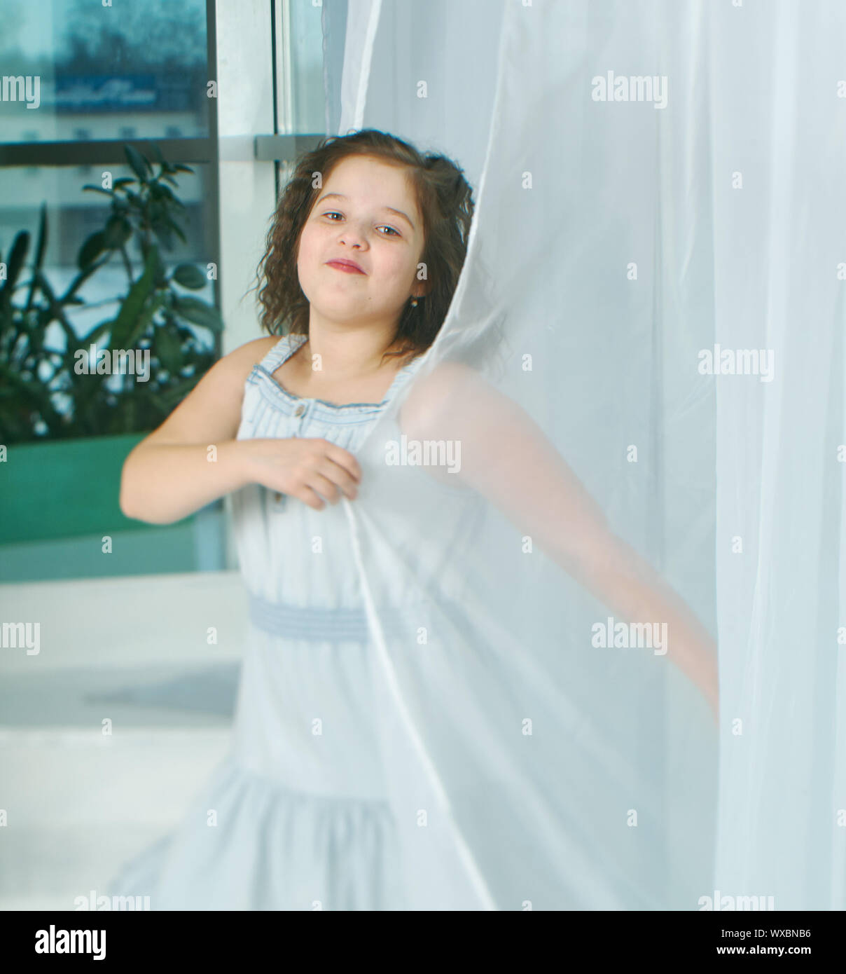 girl standing near big window Stock Photo - Alamy