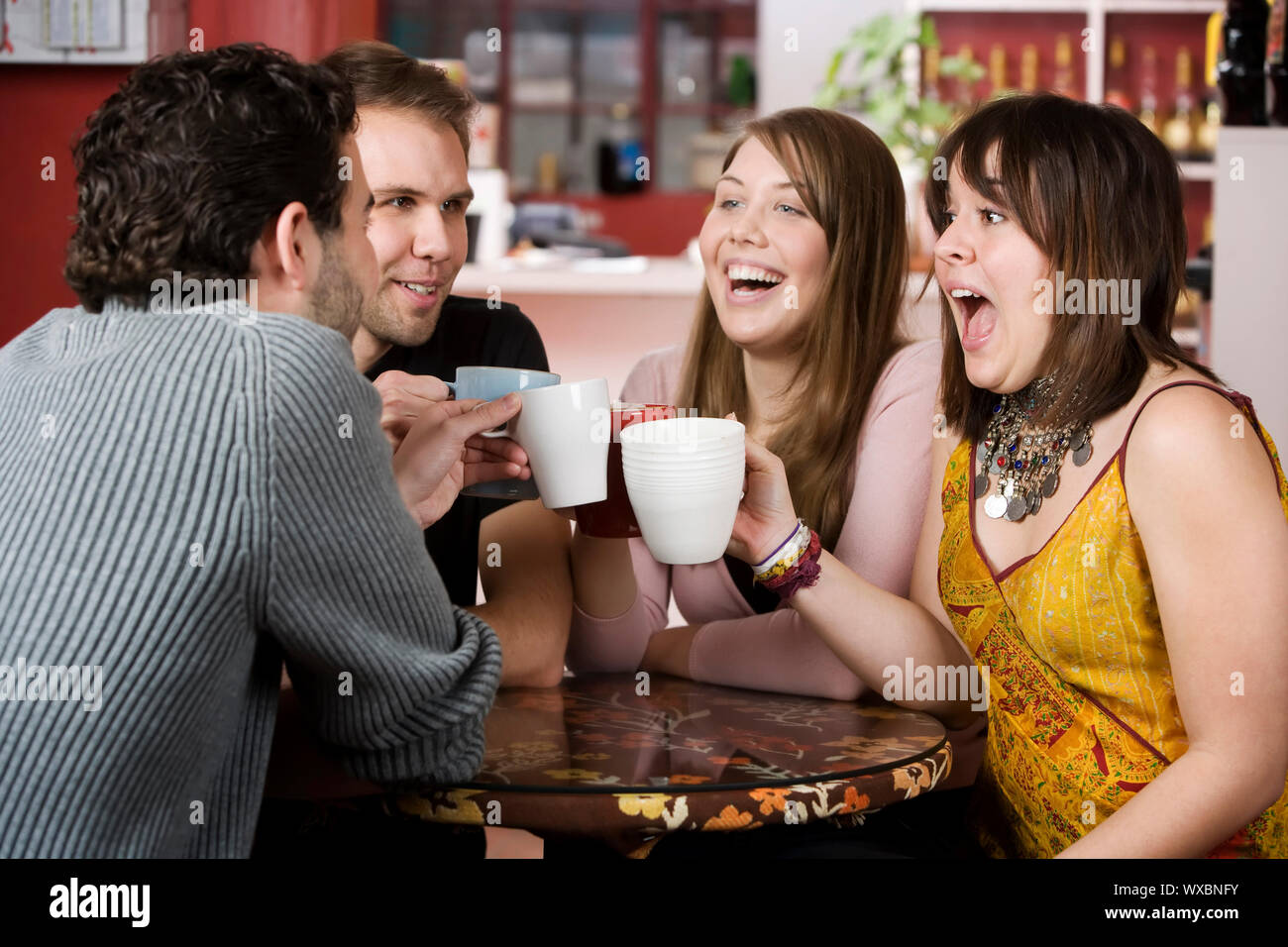 Group friends toasting coffee cups hi-res stock photography and images ...
