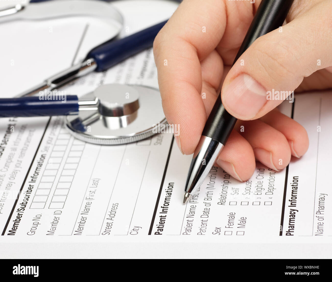 Hand with pen over blank Prescription form with patient information ...