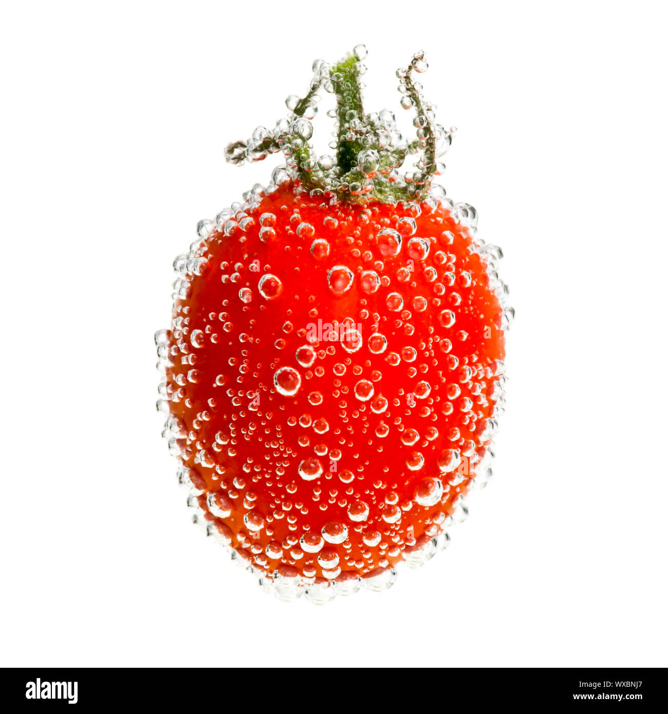 Cherry tomato in water with bubbles on white background Stock Photo - Alamy