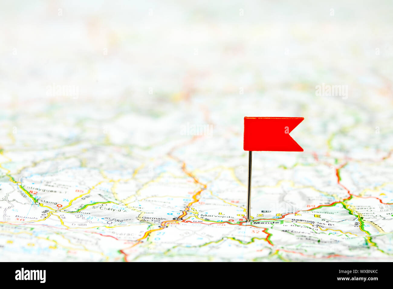 Red color flag pin on map, shallow focus Stock Photo - Alamy
