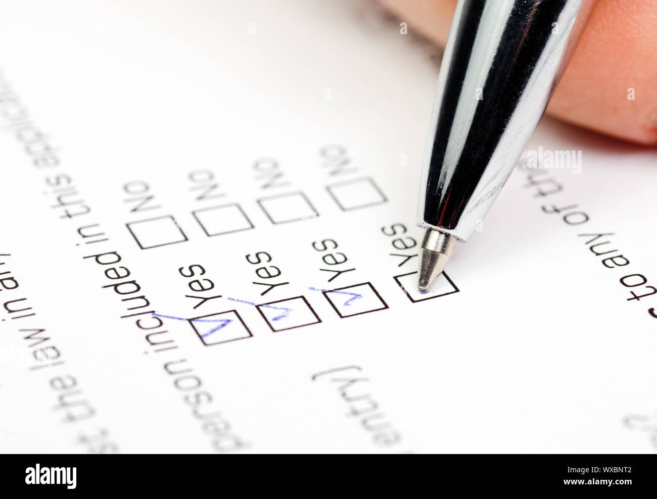 Hand with pen over blank check box Yes in application form Stock Photo ...