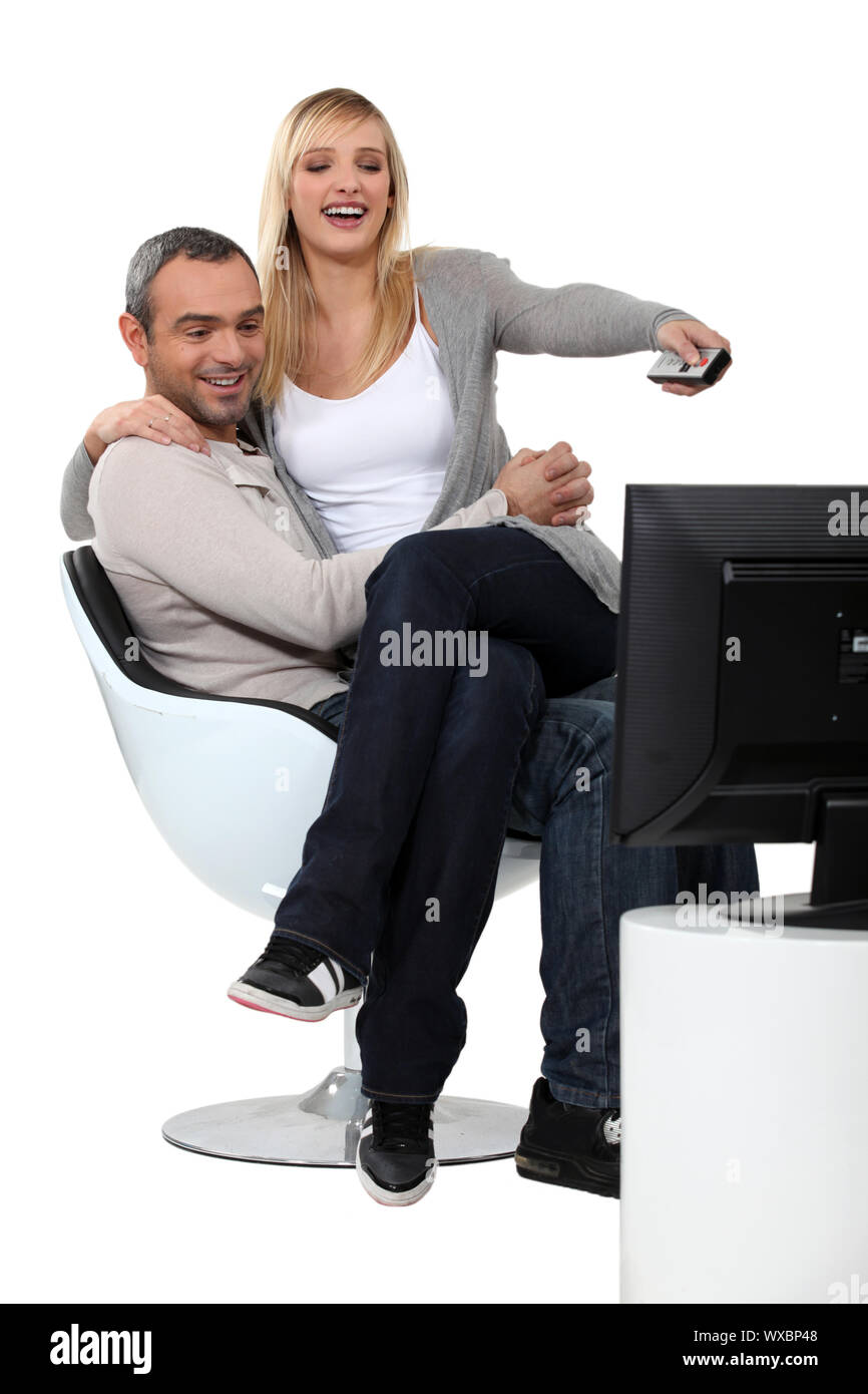 Couple channel surfing Stock Photo - Alamy