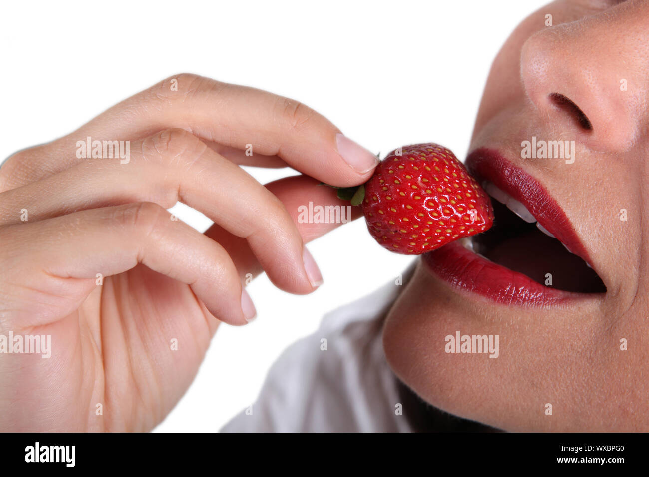 Woman eating strawberry Stock Photo - Alamy