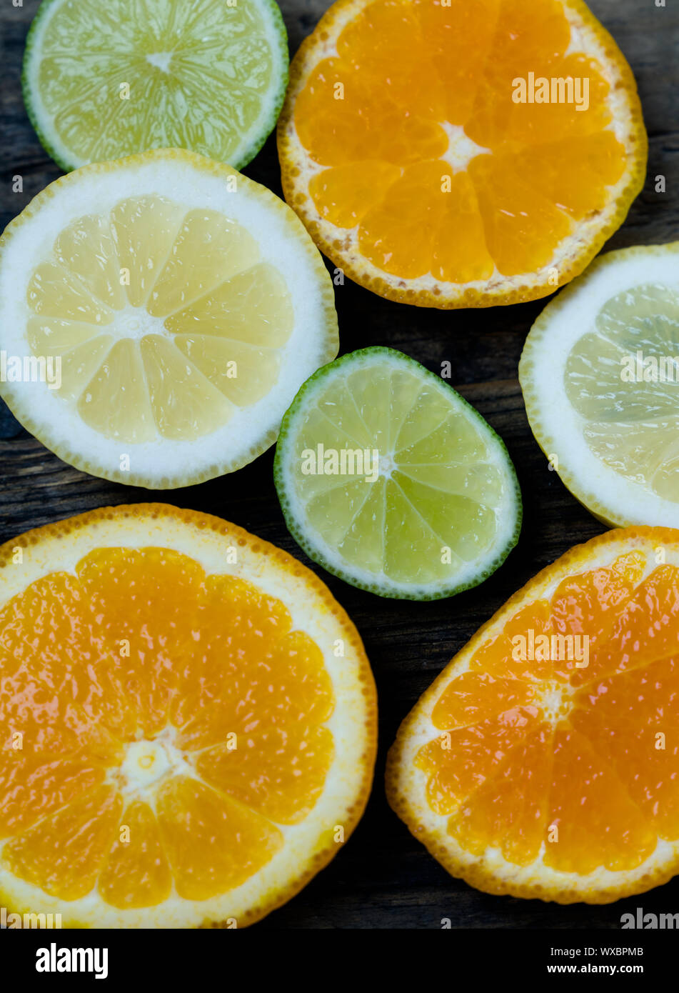 selection of slices of citrus fruit on a rustic wood background Stock ...