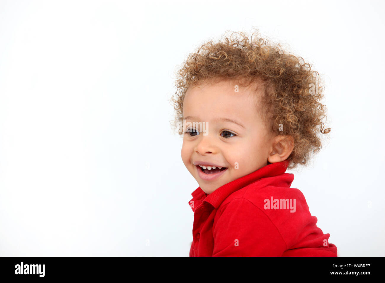 Portrait of baby with curly hair Stock Photo - Alamy