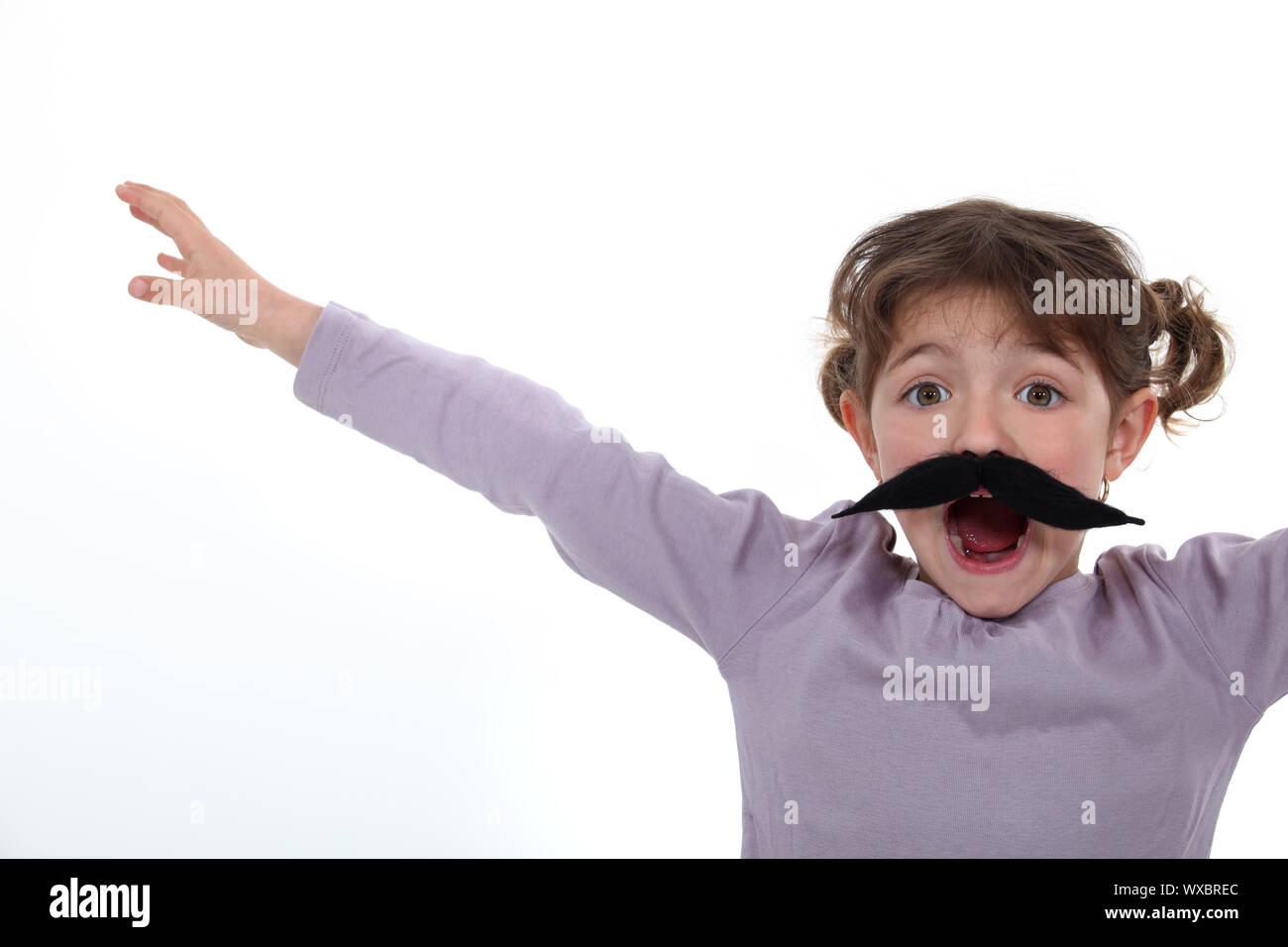 Little girl wearing a fake moustache Stock Photo - Alamy